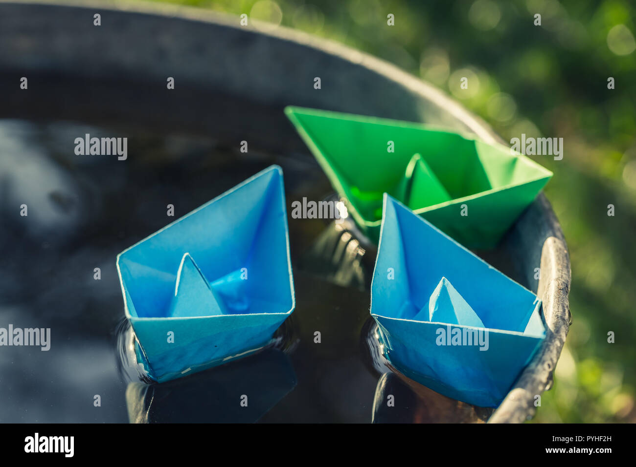 Small blue paper boats as toned and filtered photo Stock Photo - Alamy