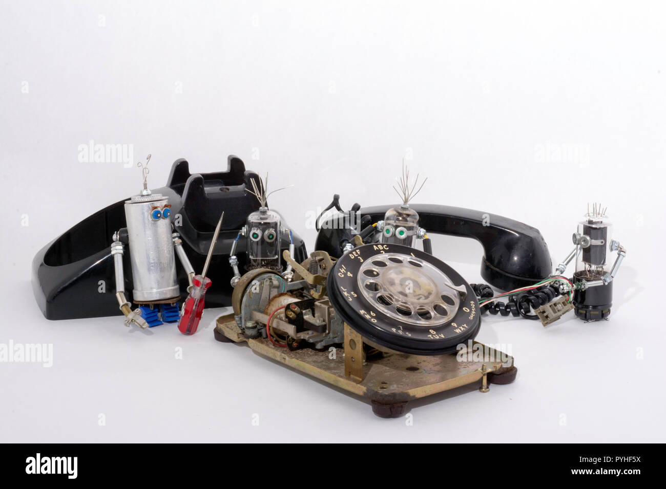 Robots repairing vintage rotary telephone Stock Photo - Alamy