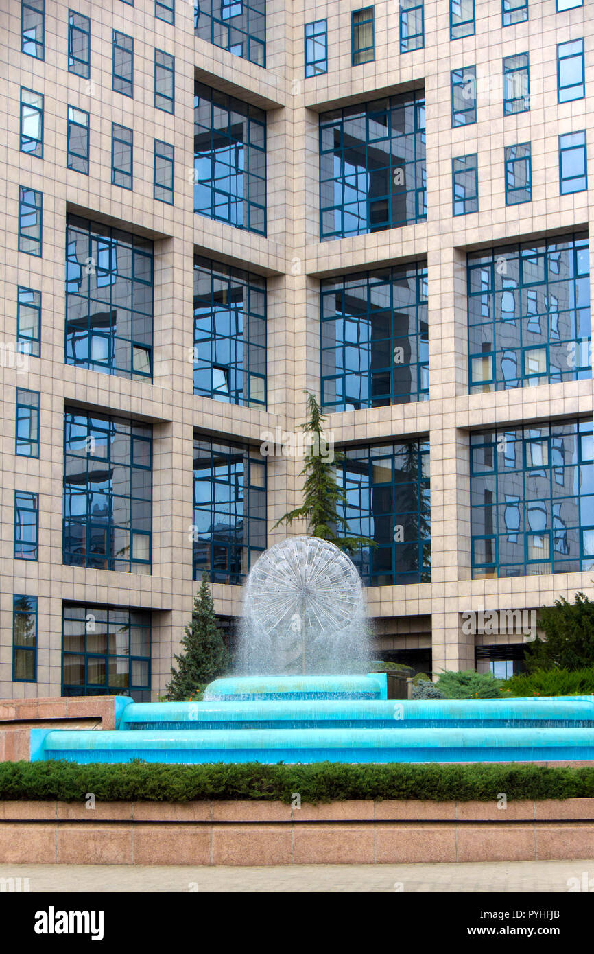 Modern style office building, with a fountain located in front of the ...