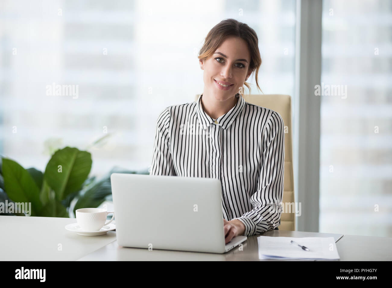 Head shot portrait of confident businesswoman at workplace Stock Photo ...