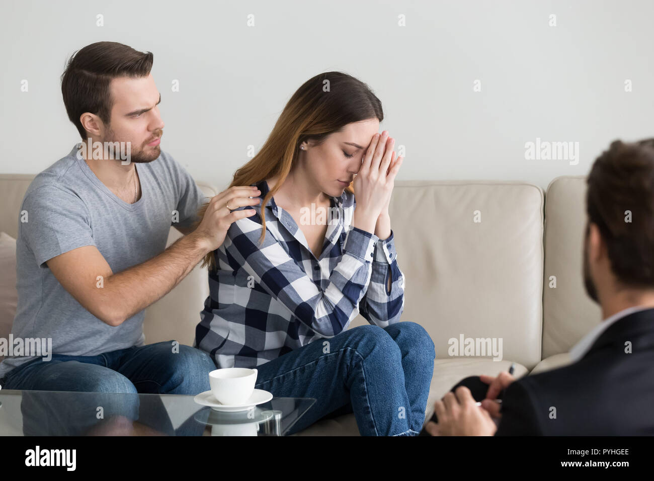 Young man, husband calming and supporting woman Stock Photo - Alamy