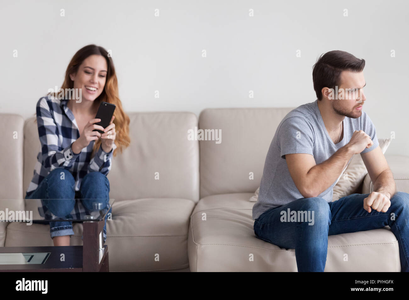 Woman communicates by phone behind man back Stock Photo - Alamy