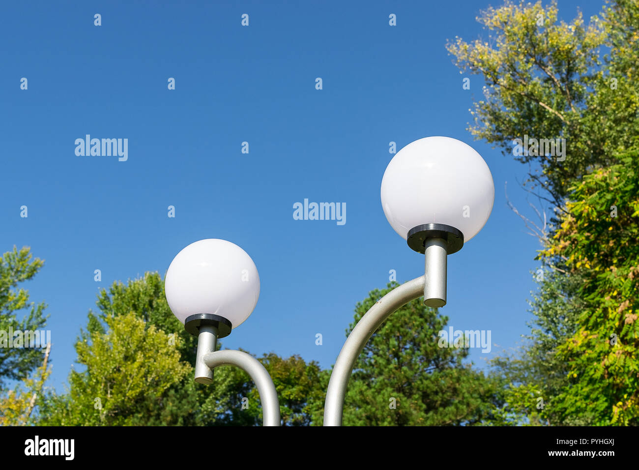 the white street lamp is turned off in the Park during the day. autumn ...