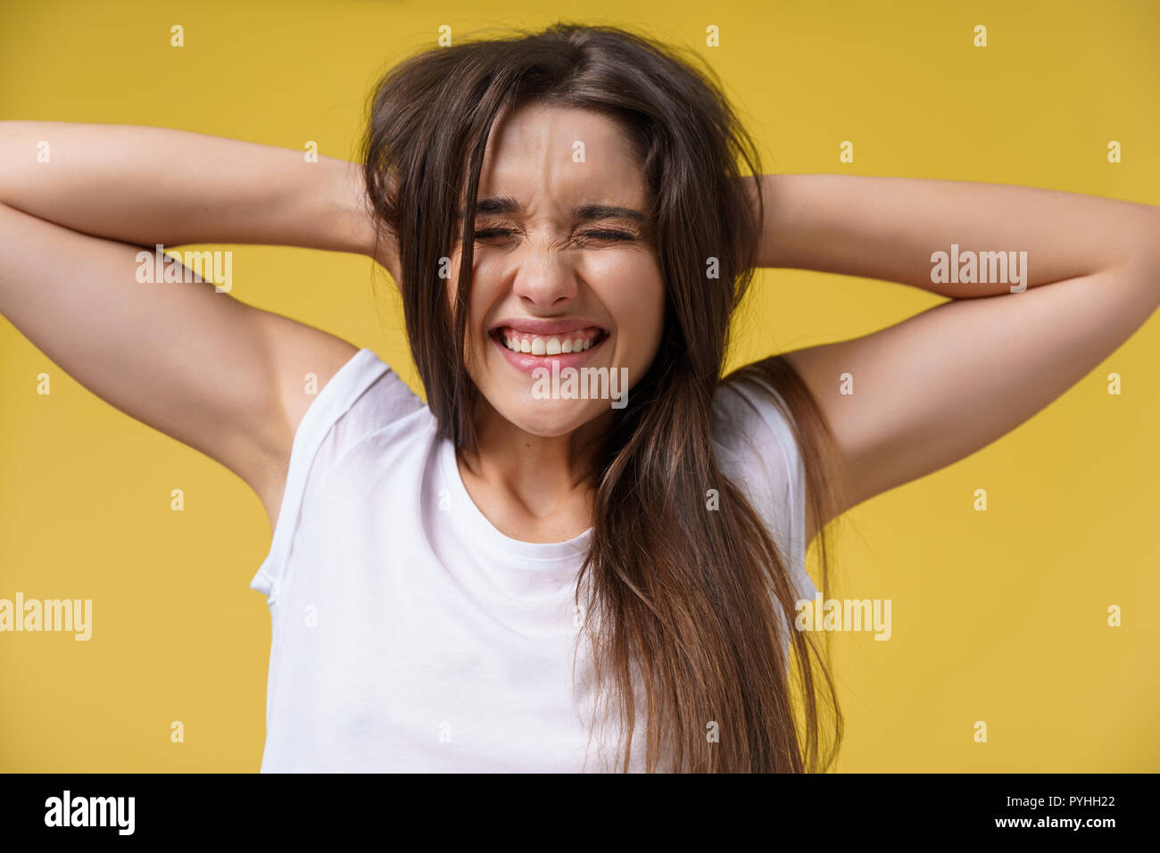 Portrait of shocked scared young woman in casual white shirt hearing ...