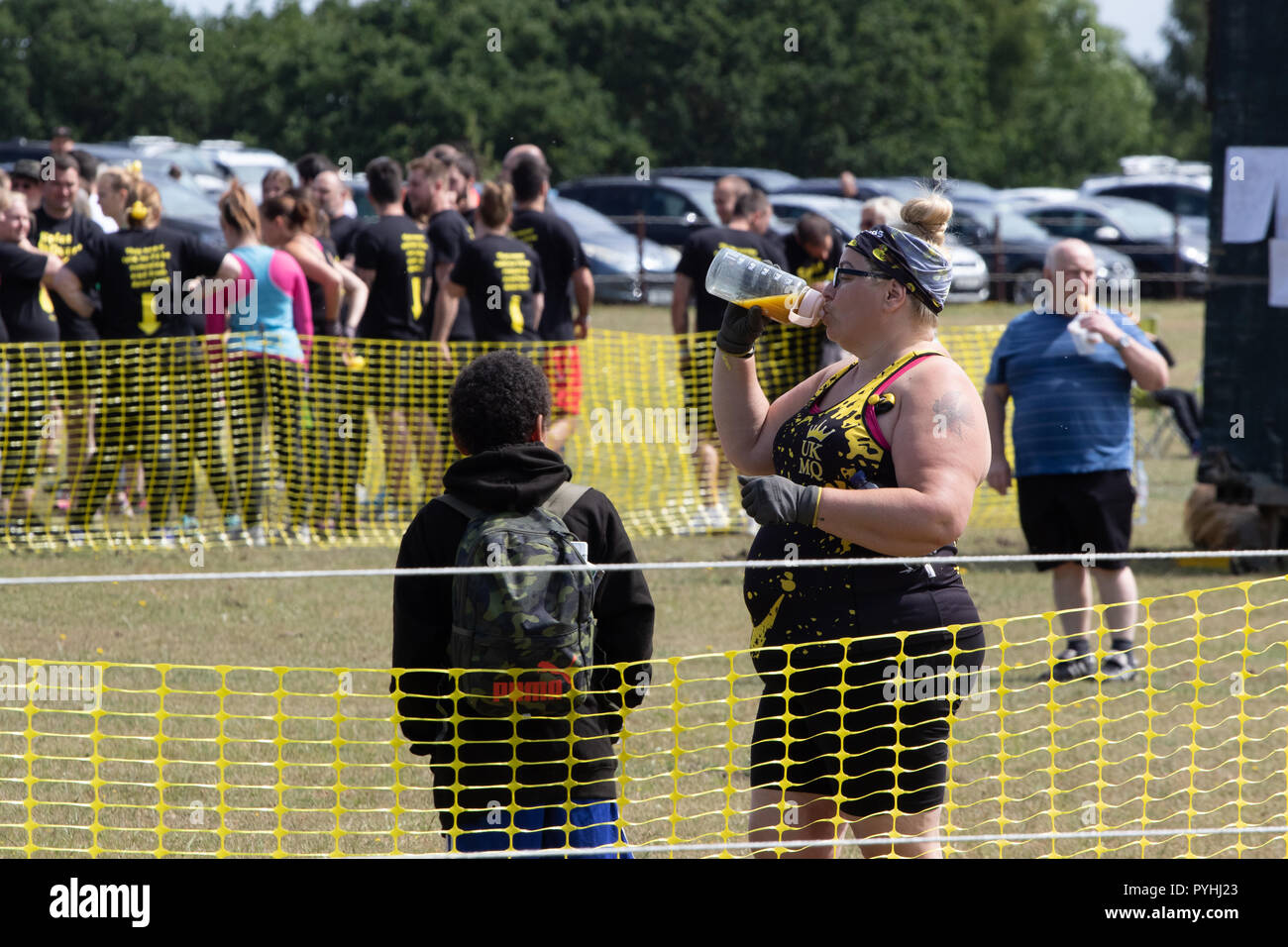 Large lady at the start of an obstacle course mud run Stock Photo - Alamy