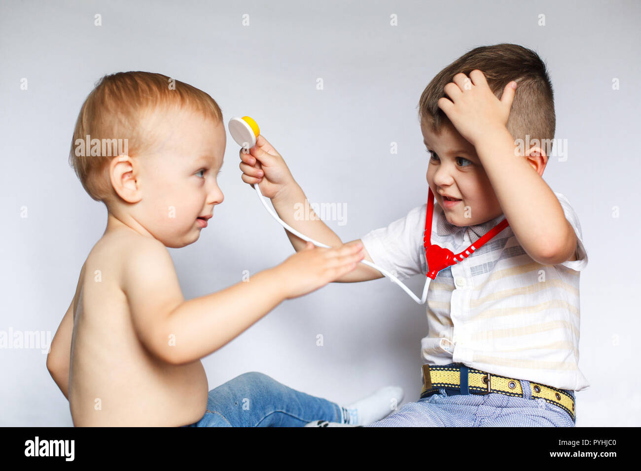 Two little boys using stethoscope. Children playing doctor and patient ...