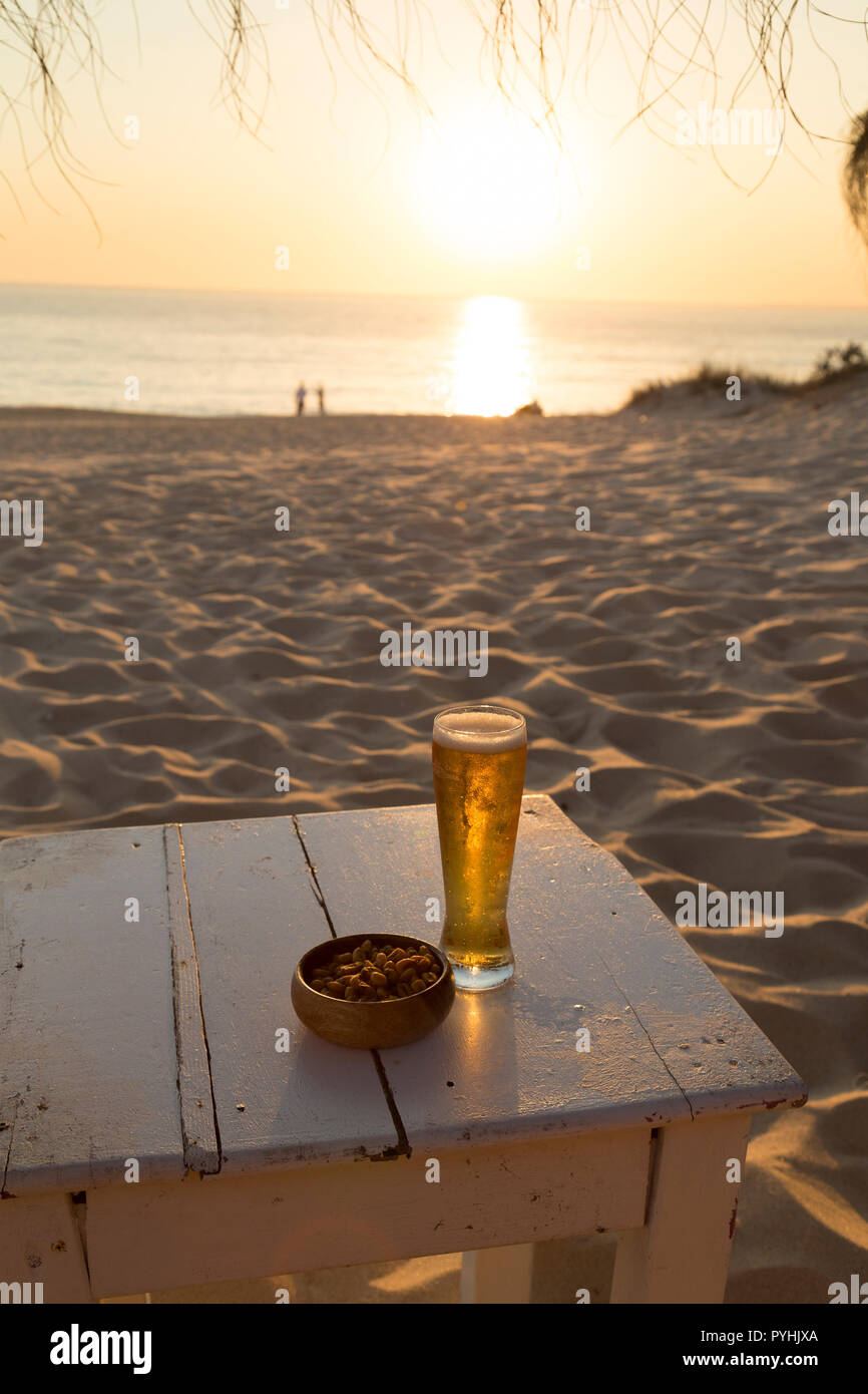 Cold beer in the hot evening sun on a Portuguese beach at sunset Stock ...