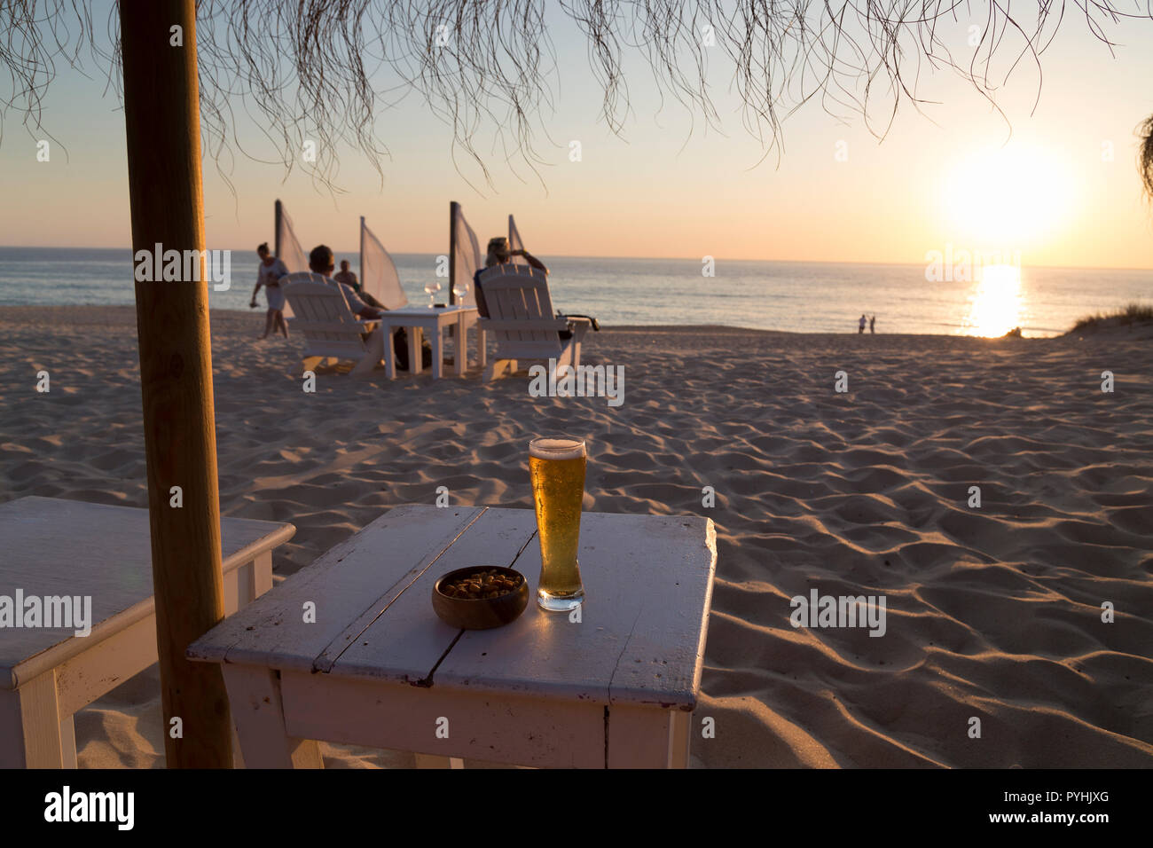 Cold beer in the hot evening sun on a Portuguese beach at sunset Stock ...