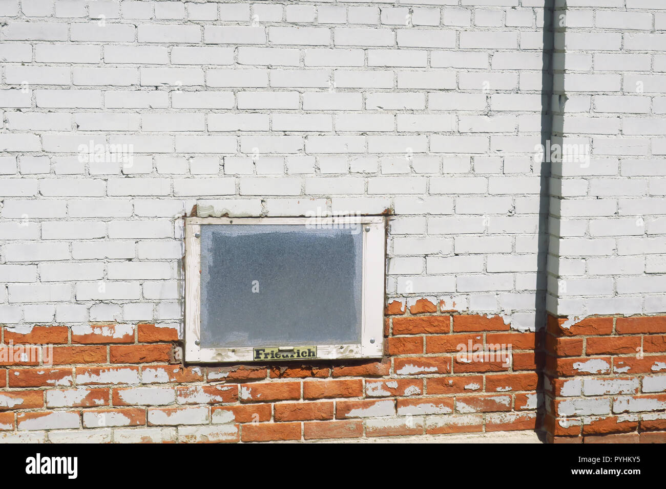 A faded white and red brick wall with a frosted window Stock Photo - Alamy