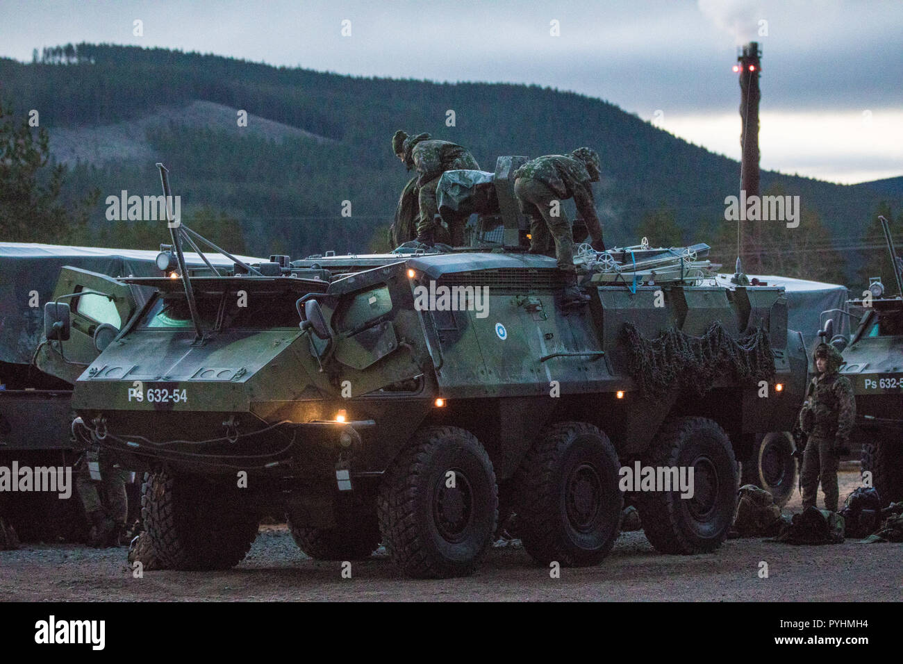 Dawn is breaking as the XA-203 armoured personnel carriers of the ...