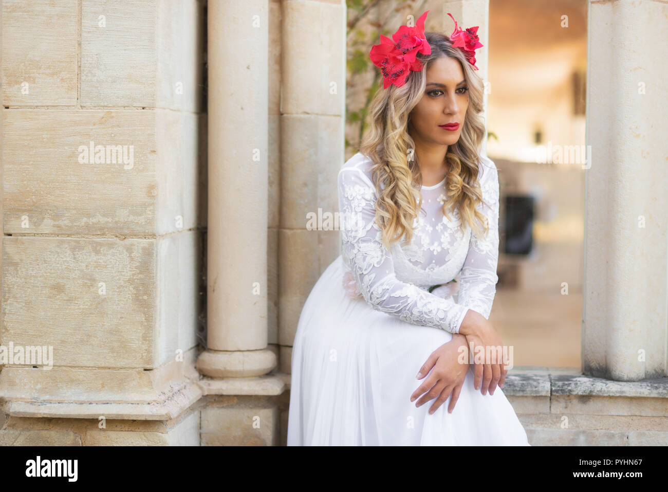 Portrait of beautiful blond girl in medieval dress with red diadem ...