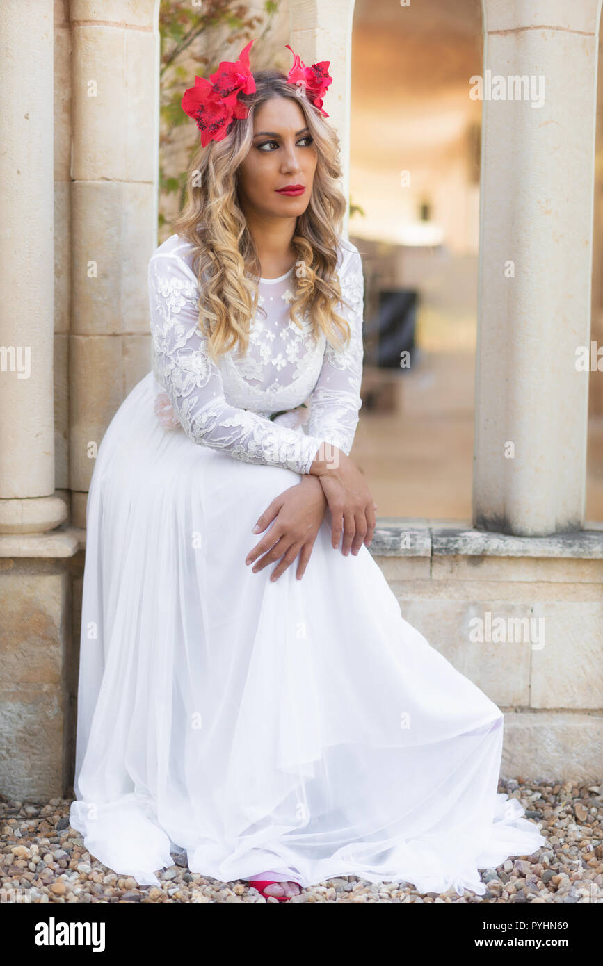Portrait of beautiful blond girl in medieval dress with red diadem ...