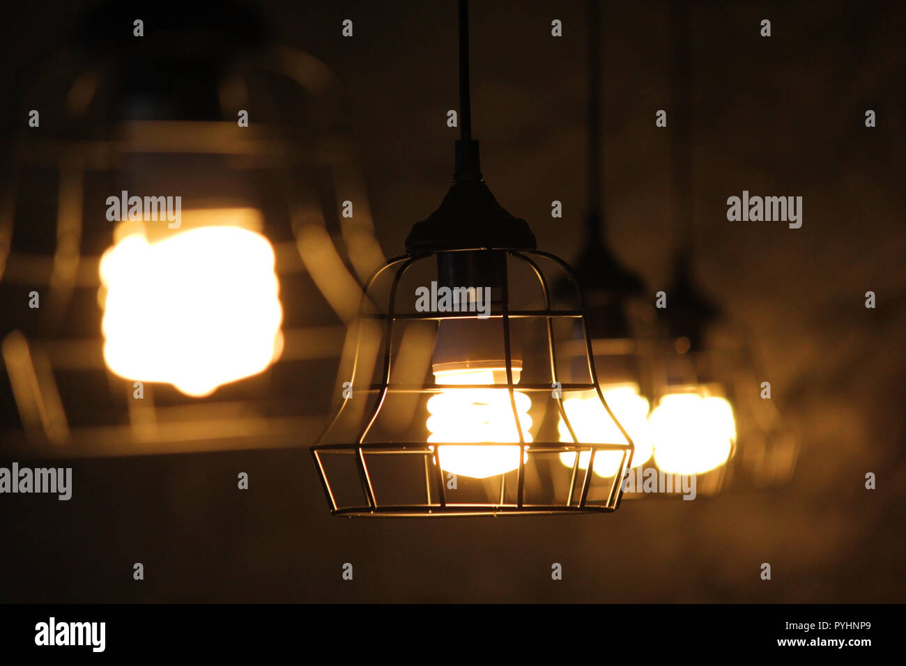 decorative lamp with turn on light bulb hanging on ceiling Stock Photo ...