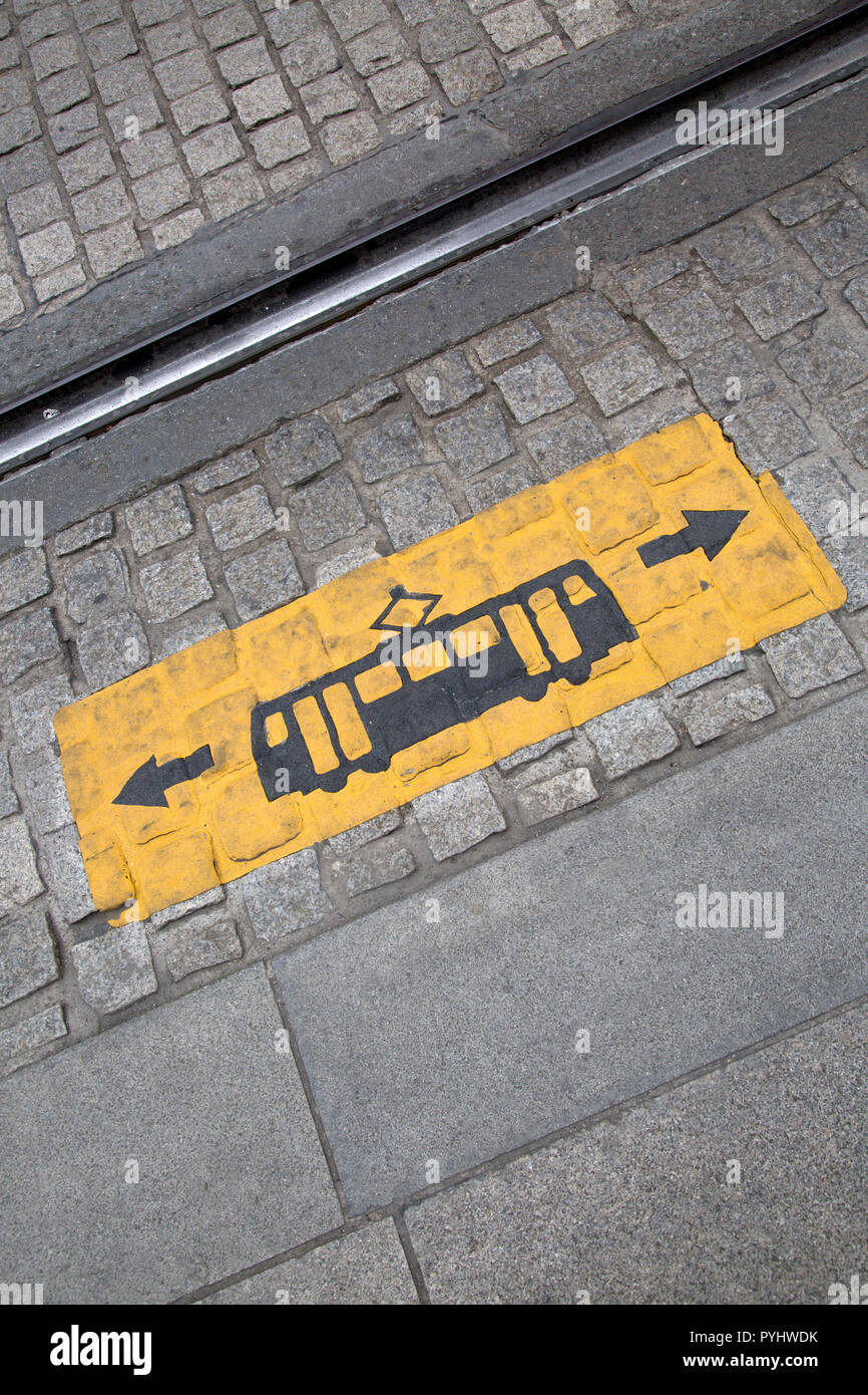 Tram Sign on Cobblestone Background Stock Photo - Alamy