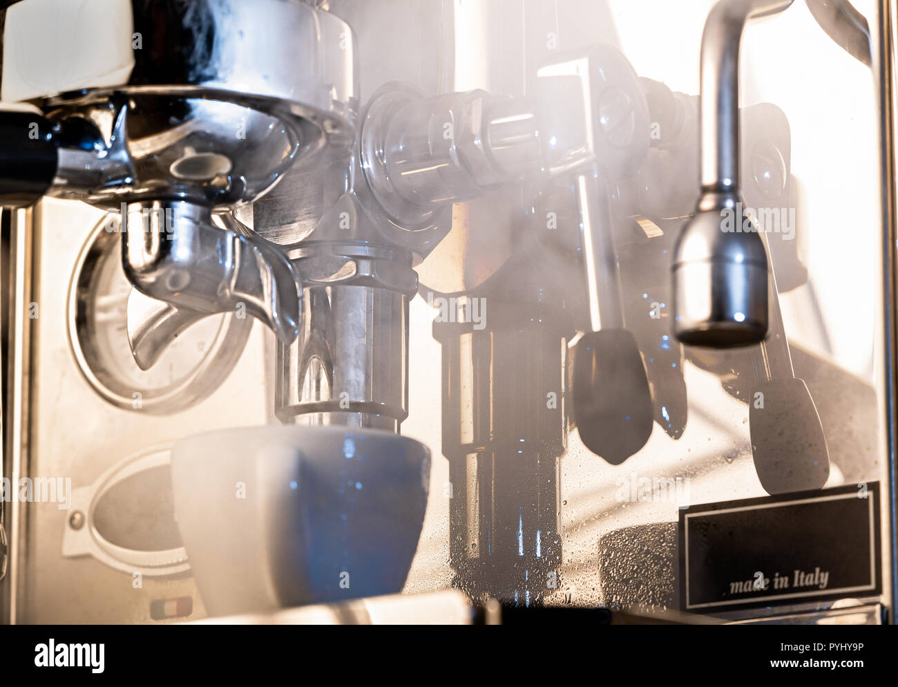 Dramatic photo of an espresso machine producing steam and water vapor ...