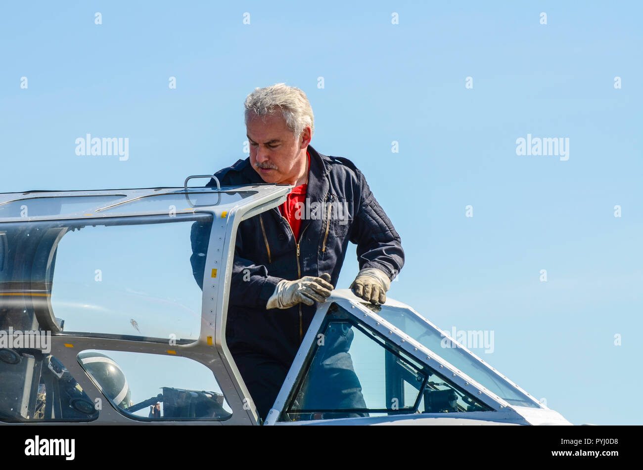 Pilot Dan Griffith climbing aboard Gloster Meteor vintage jet plane ...