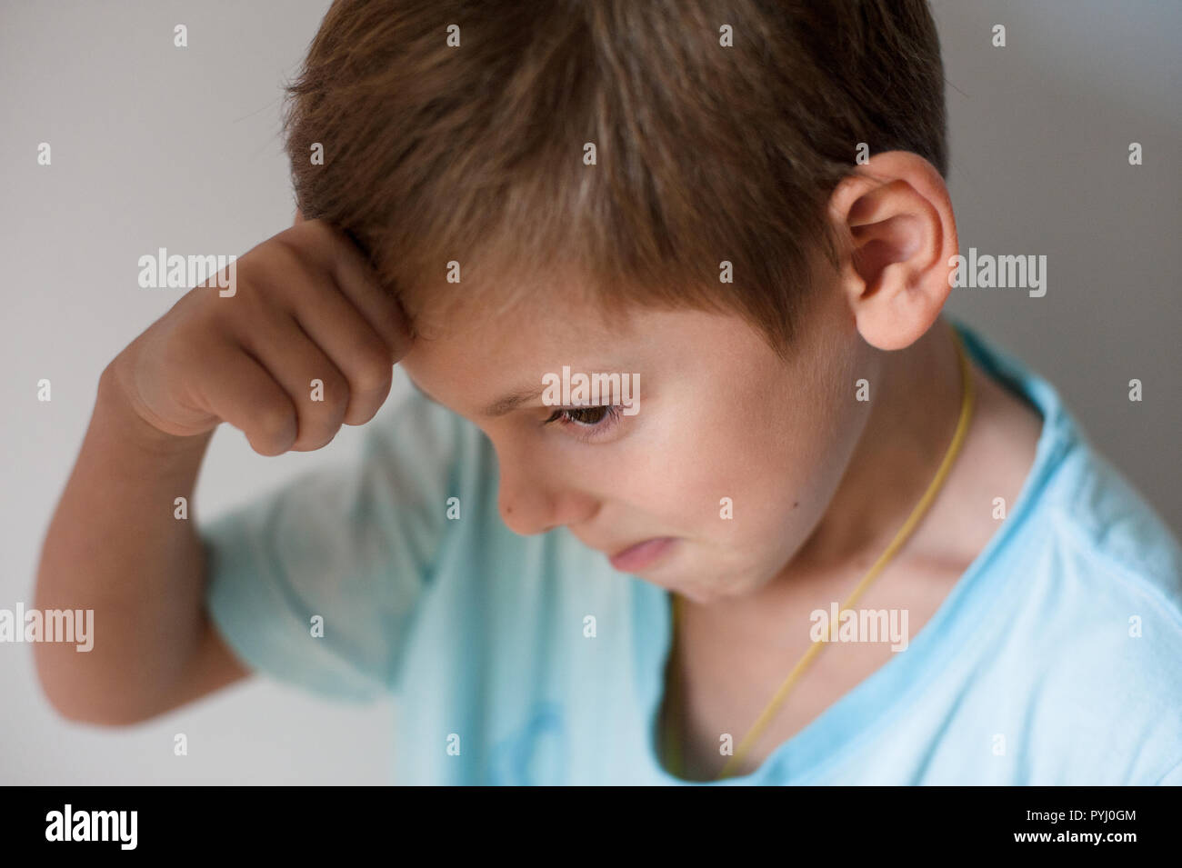 concept of thinking little boy in blue shirt mind game Stock Photo - Alamy