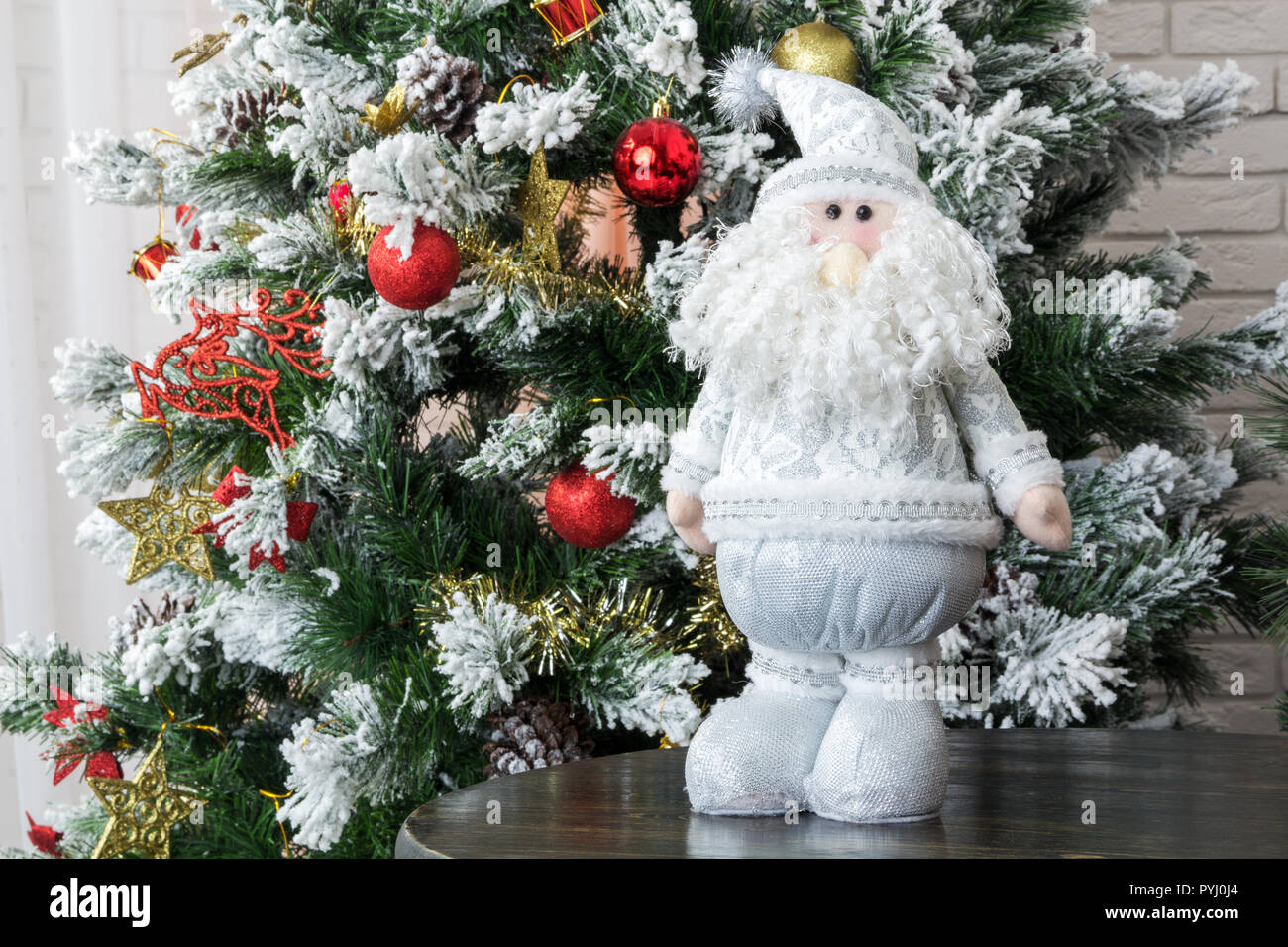 Christmas doll and decorations on Christmas tree Stock Photo - Alamy