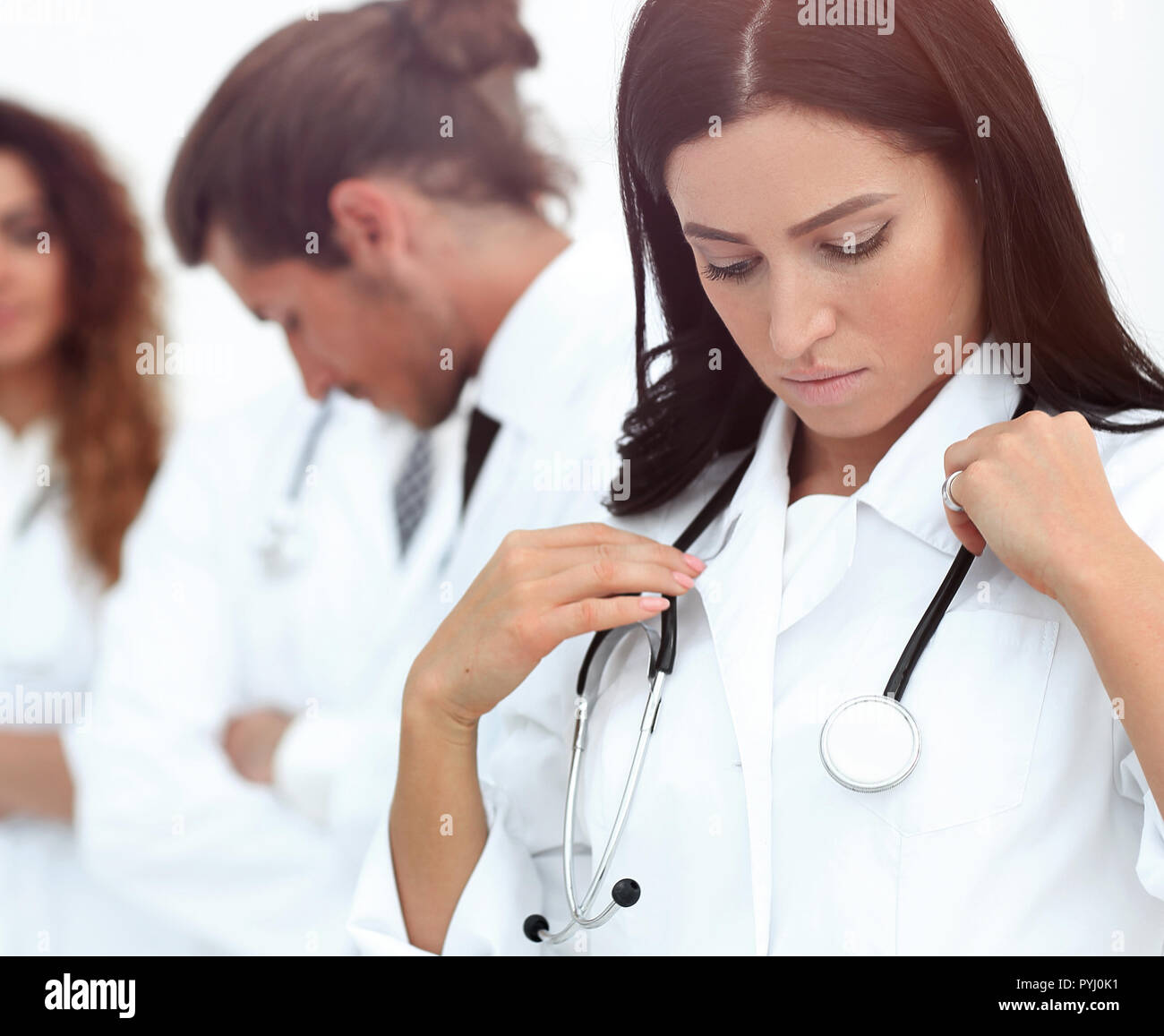 woman doctor on the background of colleagues Stock Photo - Alamy