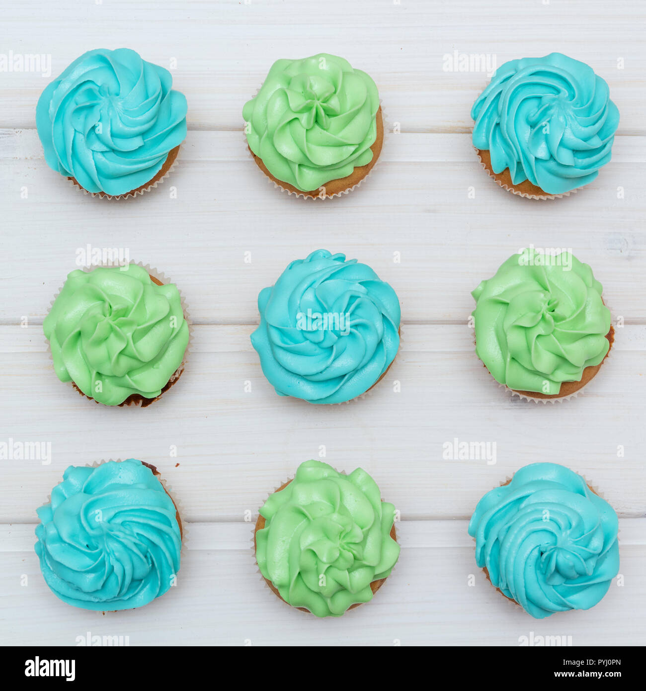 Cupcakes with green and blue cream Stock Photo - Alamy