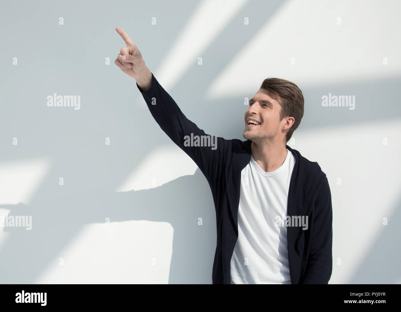 modern young man pointing to copy space.p Stock Photo - Alamy