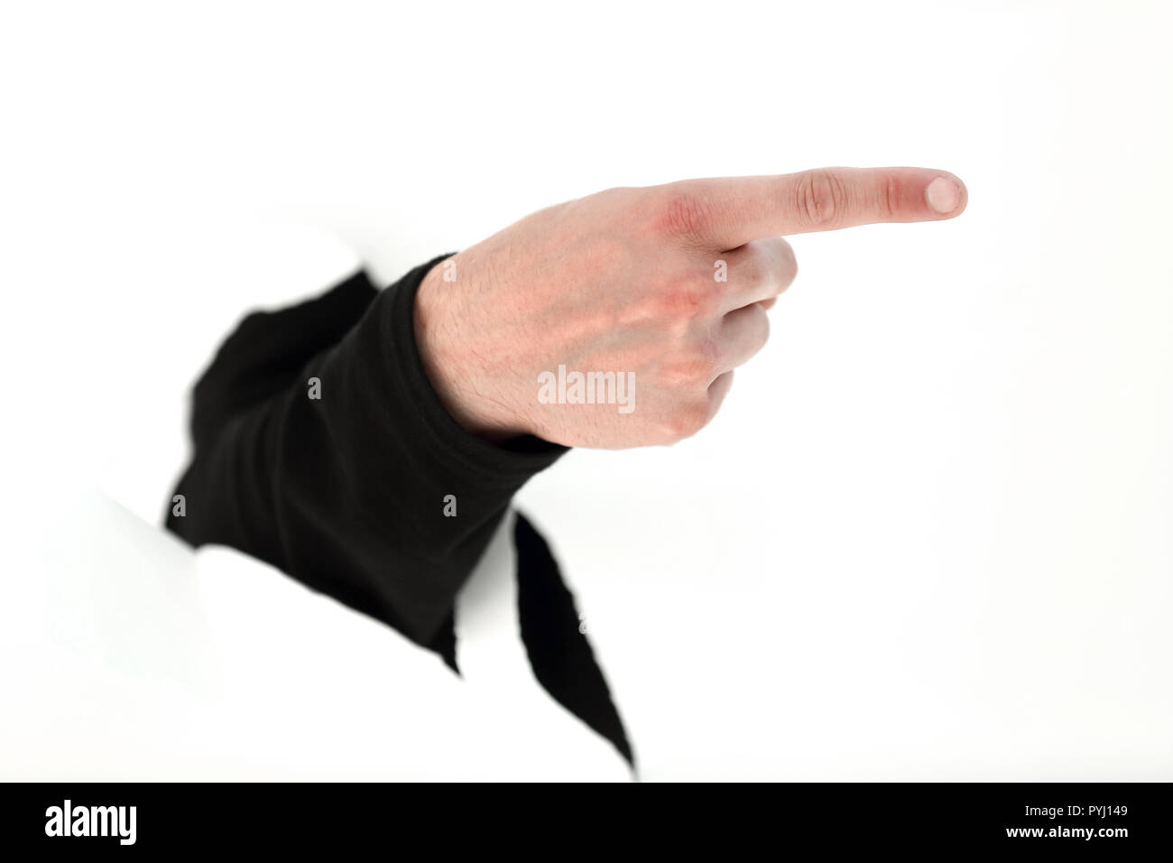 Hand point to you through a paper hole Stock Photo - Alamy