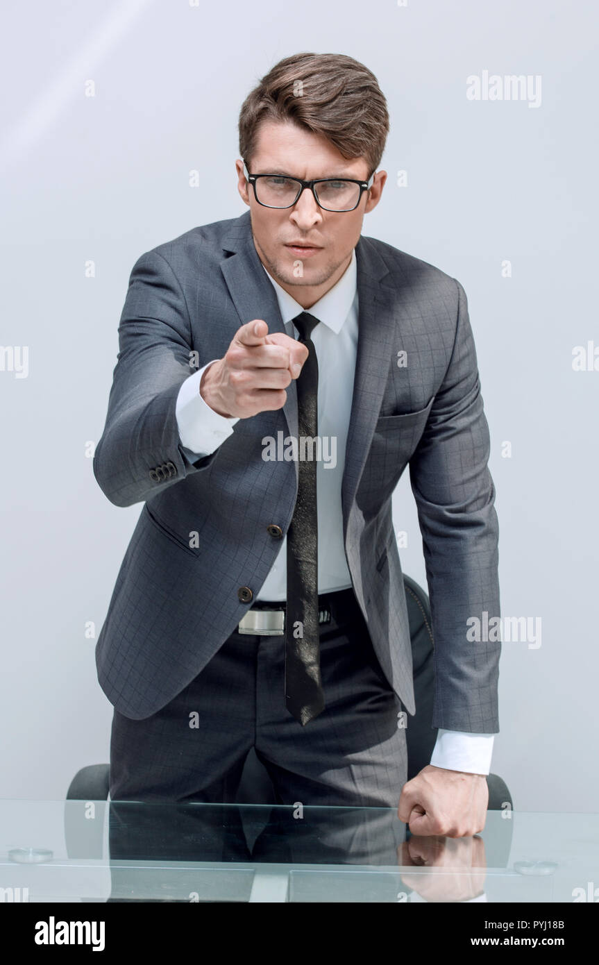 close up.strict businessman standing near the desktop Stock Photo - Alamy