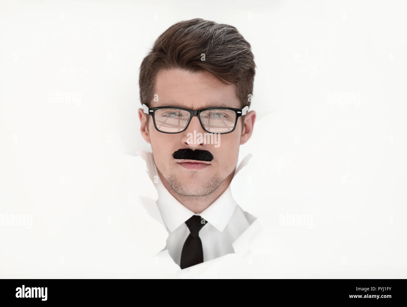 serious young businessman breaks through the paper Stock Photo - Alamy