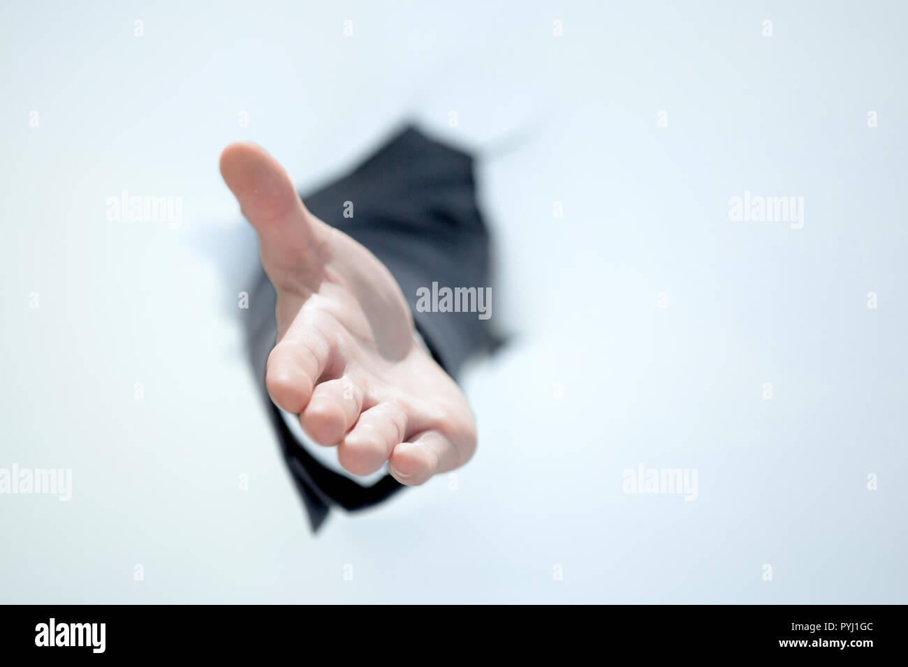 Hand breaking through paper holding hi-res stock photography and images ...