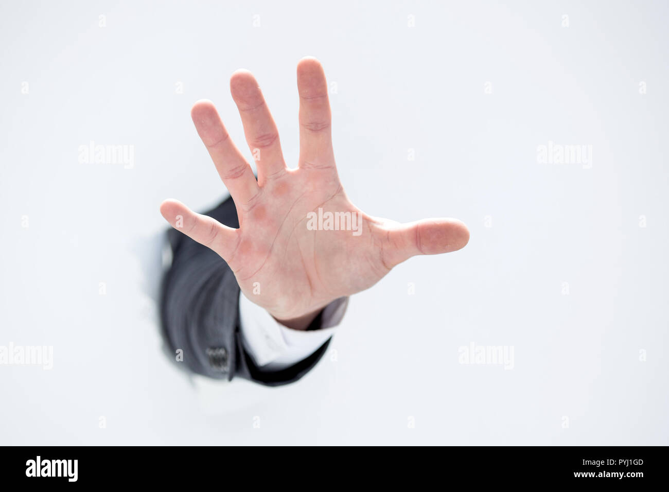 Hand breaking through paper holding hi-res stock photography and images ...