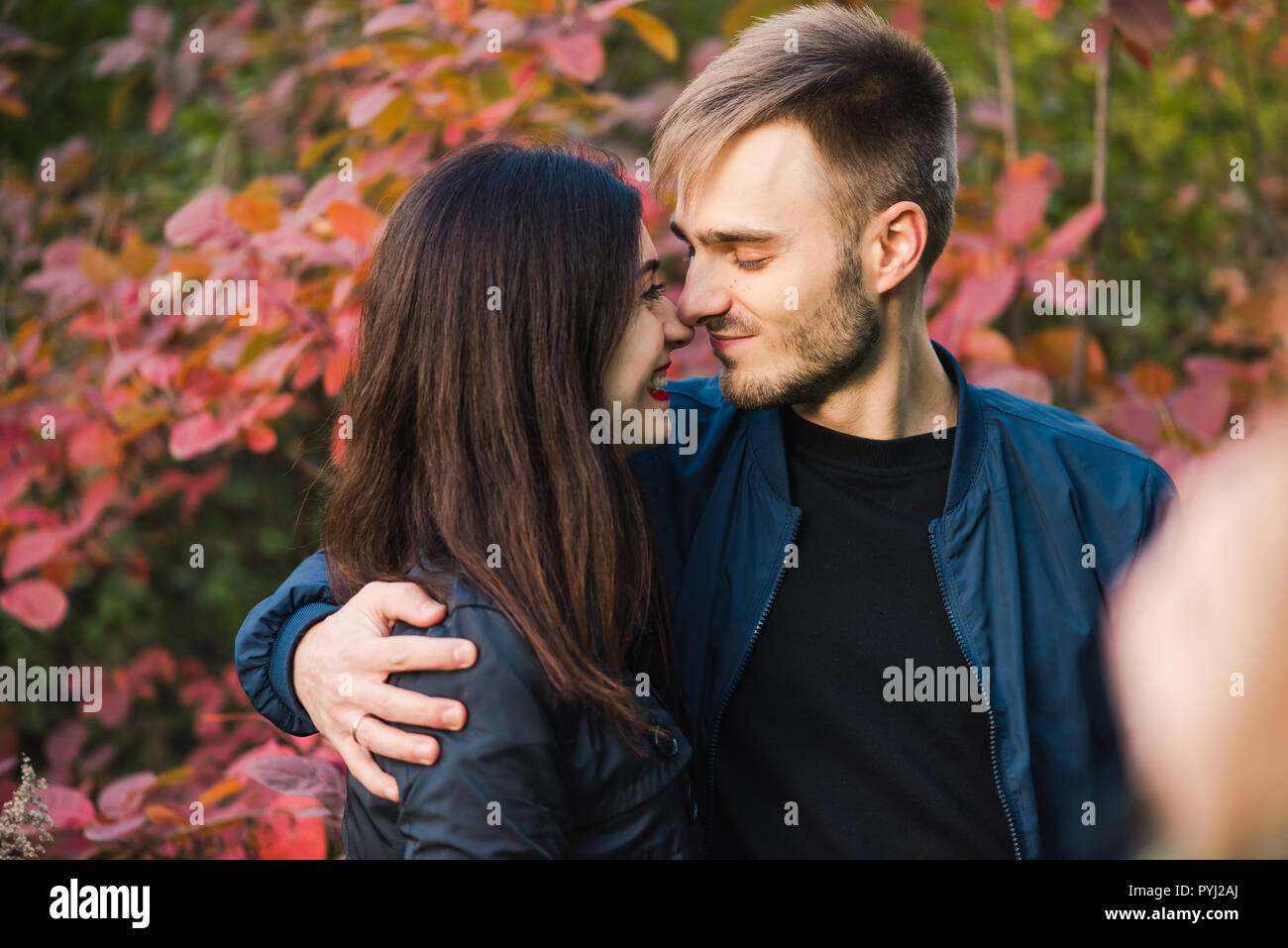 Woman and man hug and smile during walk outdoors Stock Photo - Alamy