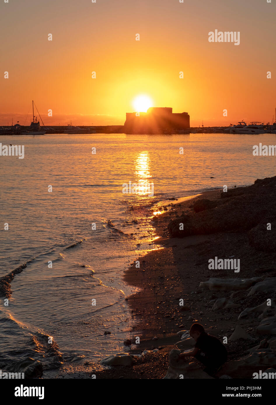 The sun sets behind Paphos Castle in Paphos, Cyprus Stock Photo - Alamy