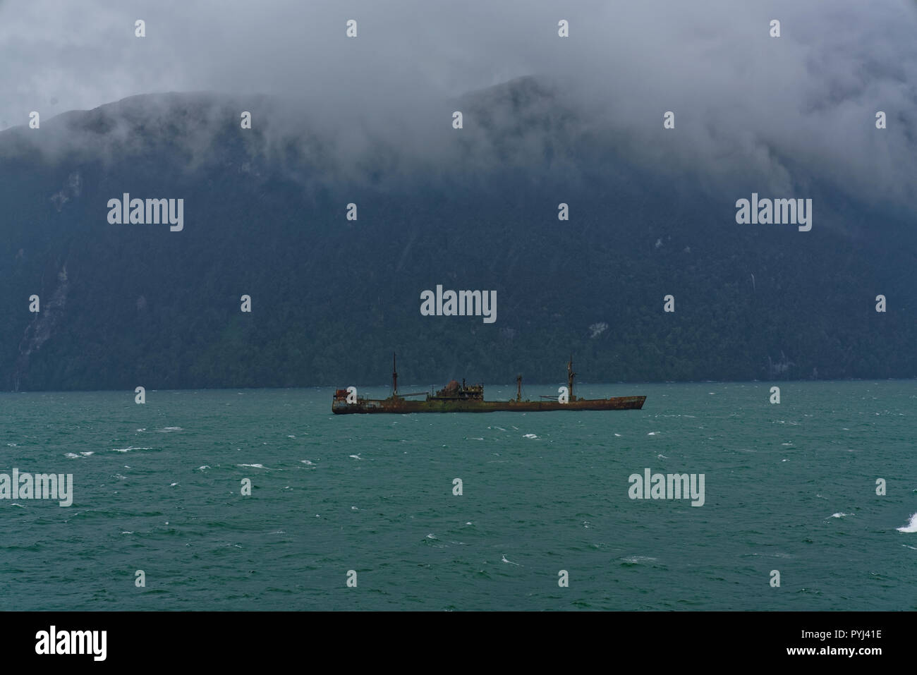 boat wrecked on the patagonian channels of chile Stock Photo - Alamy