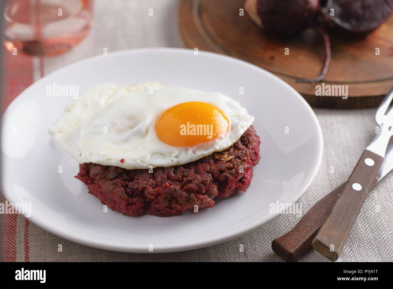 Swedish beef burger Biff a la Lindstrom with fried egg Stock Photo - Alamy