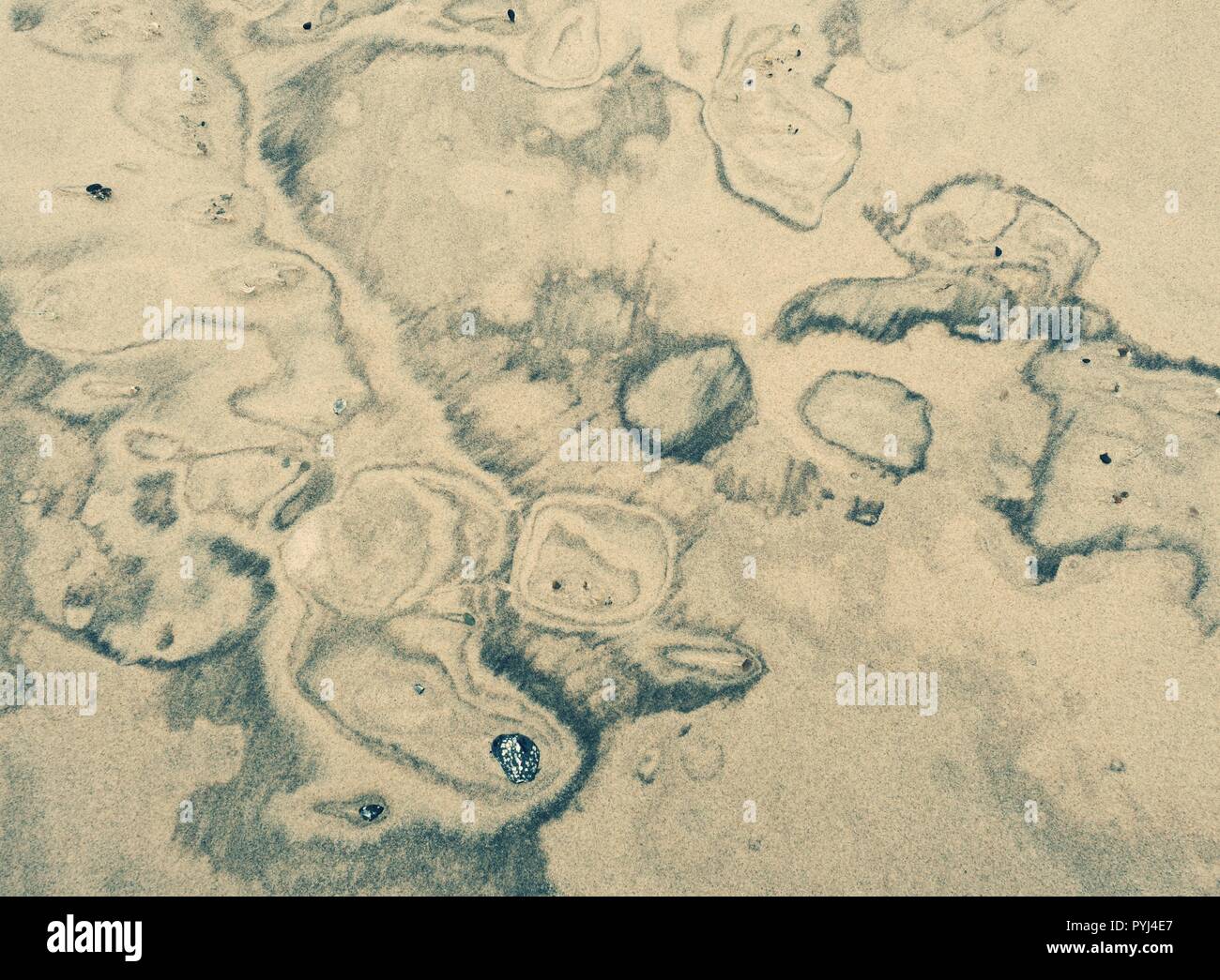 Sediments in wet sand created natural kind of picture. Swirls with a ...