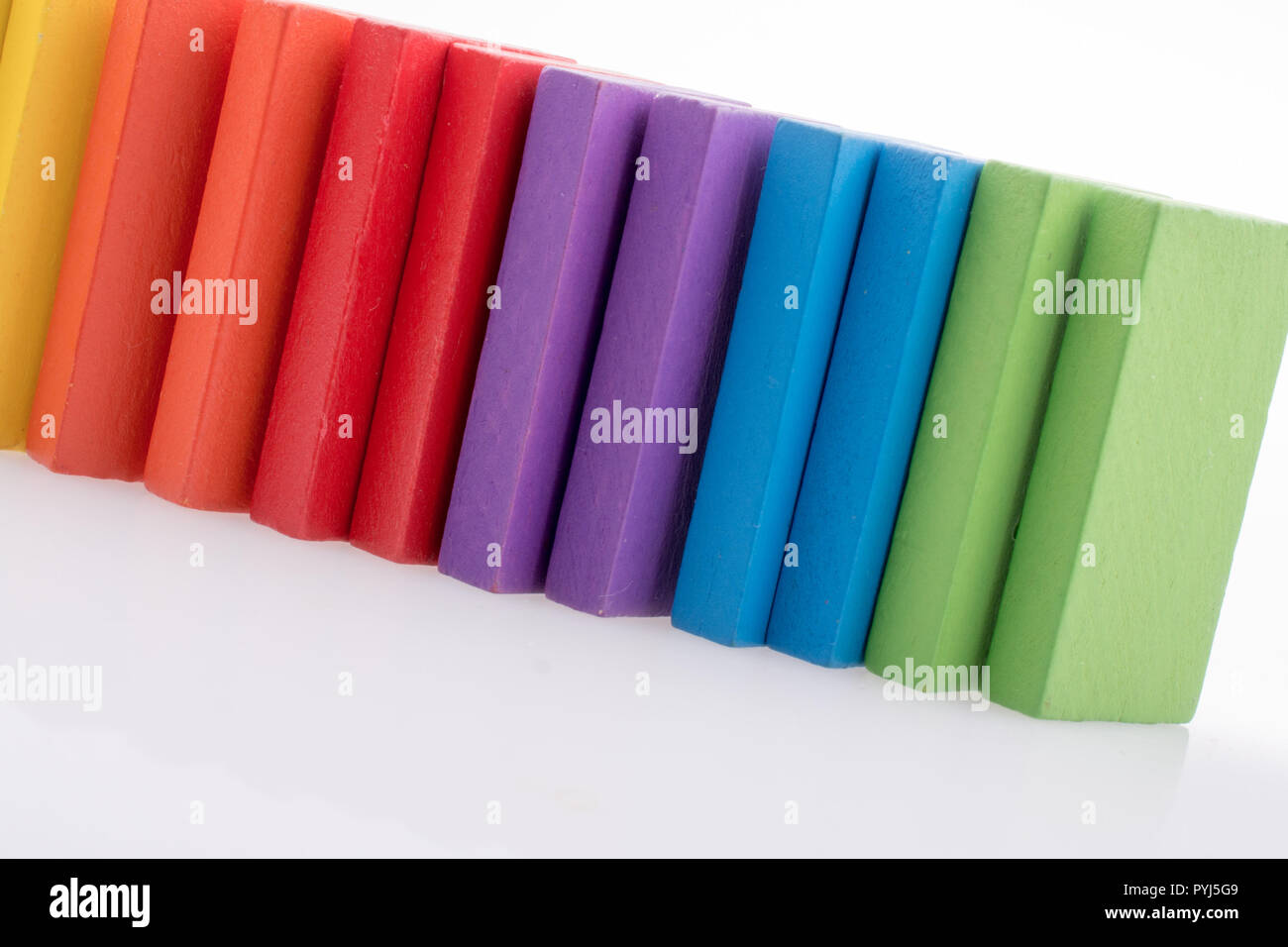 Colorful Domino Blocks in a line on a white background Stock Photo - Alamy