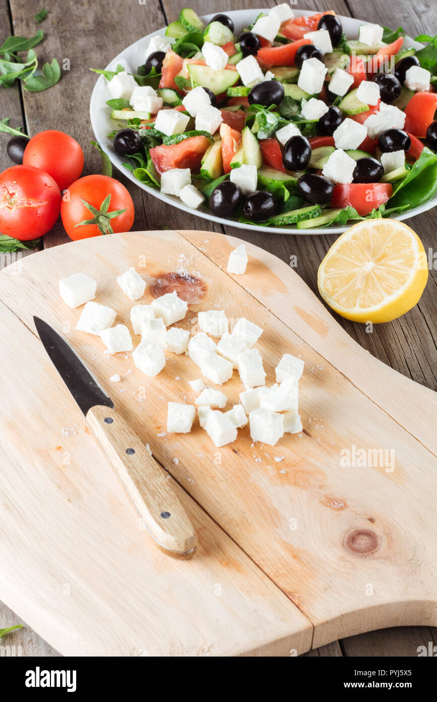 Cooking Greek salad, sliced feta cheese closeup Stock Photo - Alamy