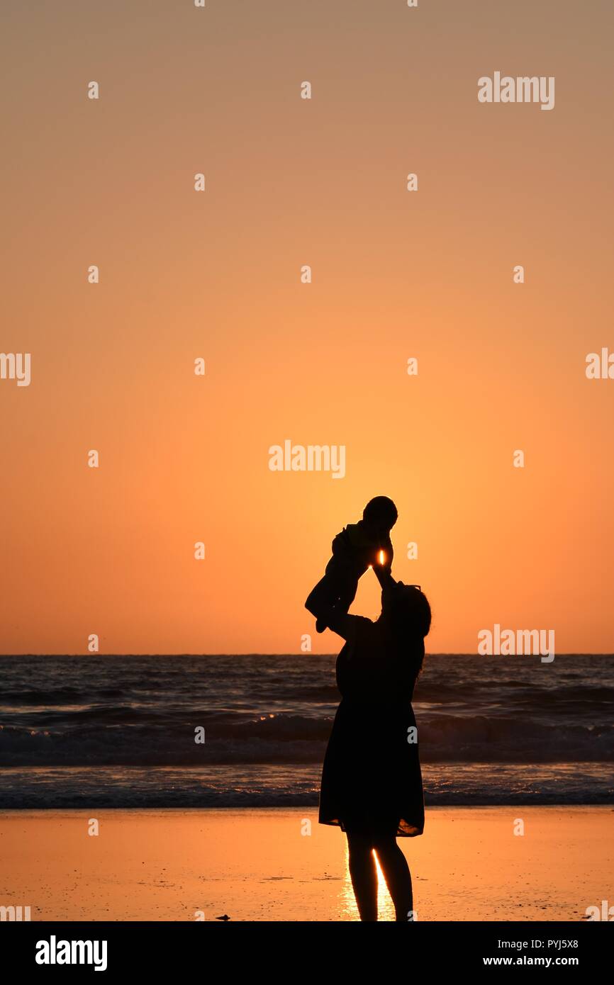 Mother lifting son Stock Photo - Alamy