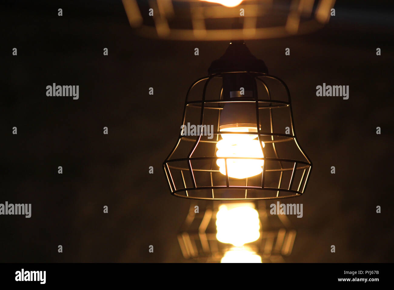 decorative lamp with turn on light bulb hanging on ceiling Stock Photo ...