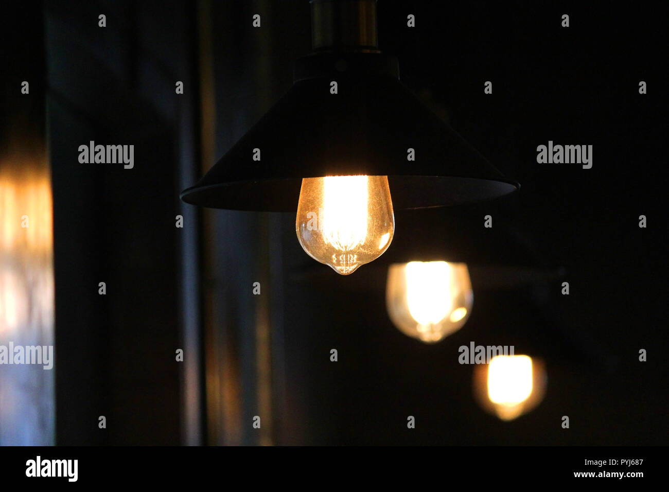 decorative lamp with turn on light bulb hanging on ceiling Stock Photo ...