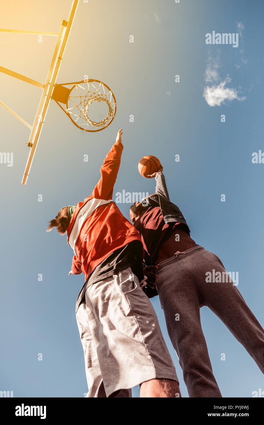 Low angle of young well built men throwing the ball Stock Photo - Alamy