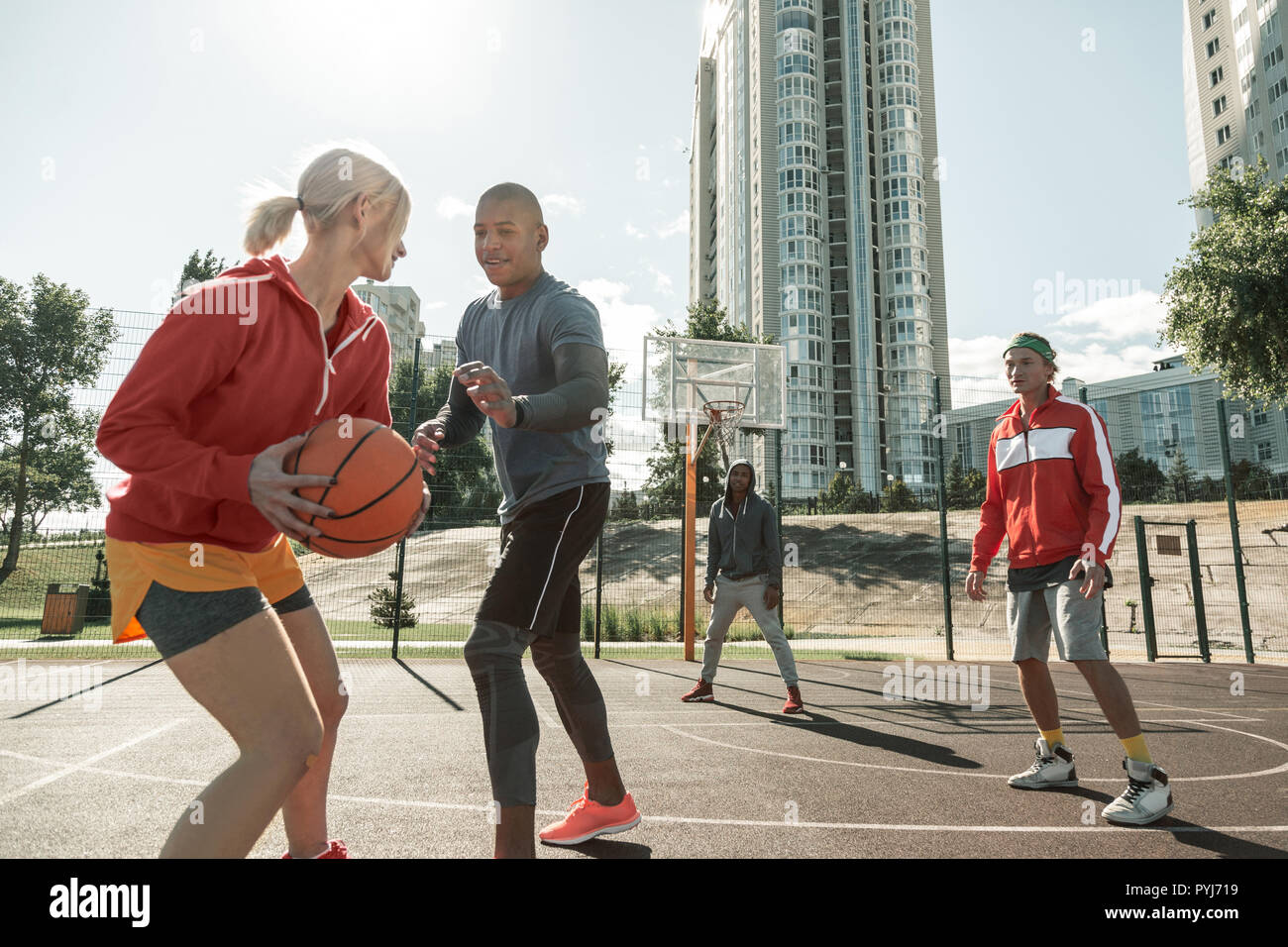 Nice young woman running with a ball Stock Photo - Alamy