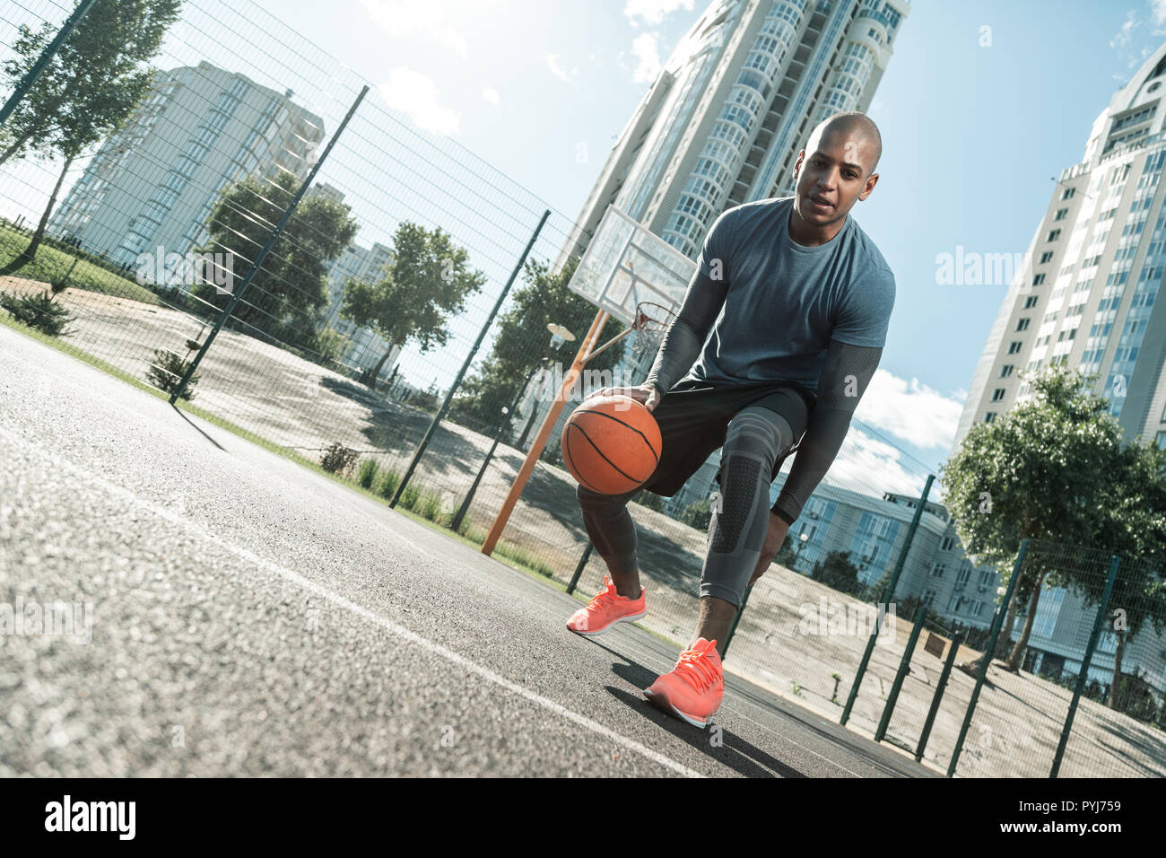 Happy active man playing on the basketball court Stock Photo - Alamy