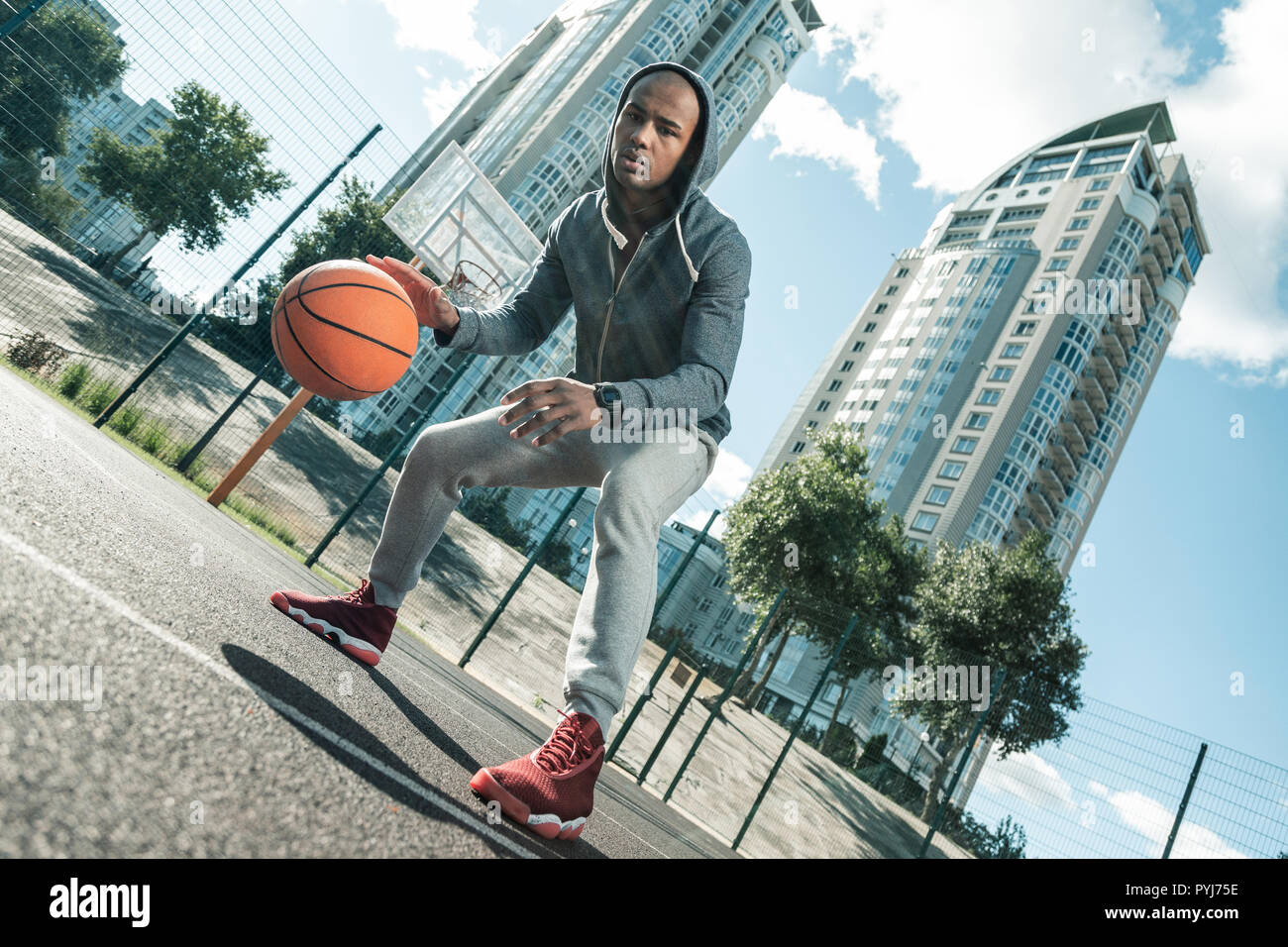 Pleasant young man playing with a ball Stock Photo - Alamy