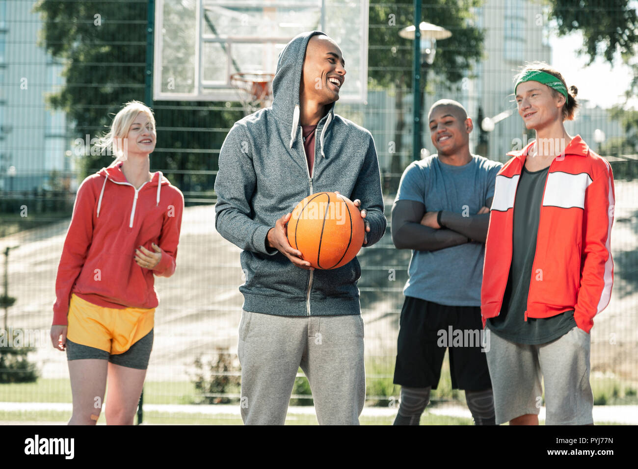 Positive delighted man laughing with his friends Stock Photo - Alamy