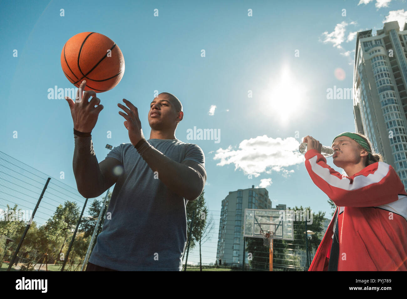 Pleasant young man learning how to rotate the ball Stock Photo - Alamy