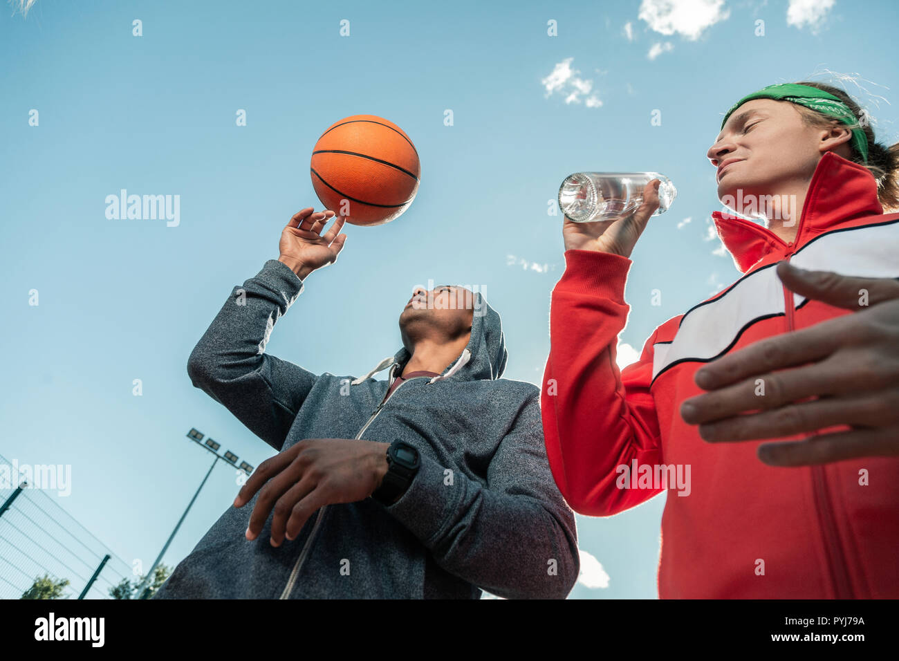 Positive handsome man playing with a ball Stock Photo - Alamy