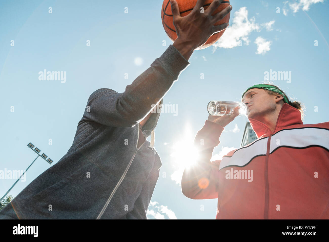 Low angle of a pleasant nice man drinking water Stock Photo - Alamy