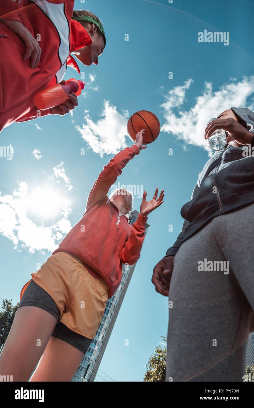 Low angle of nice young men throwing the ball Stock Photo - Alamy