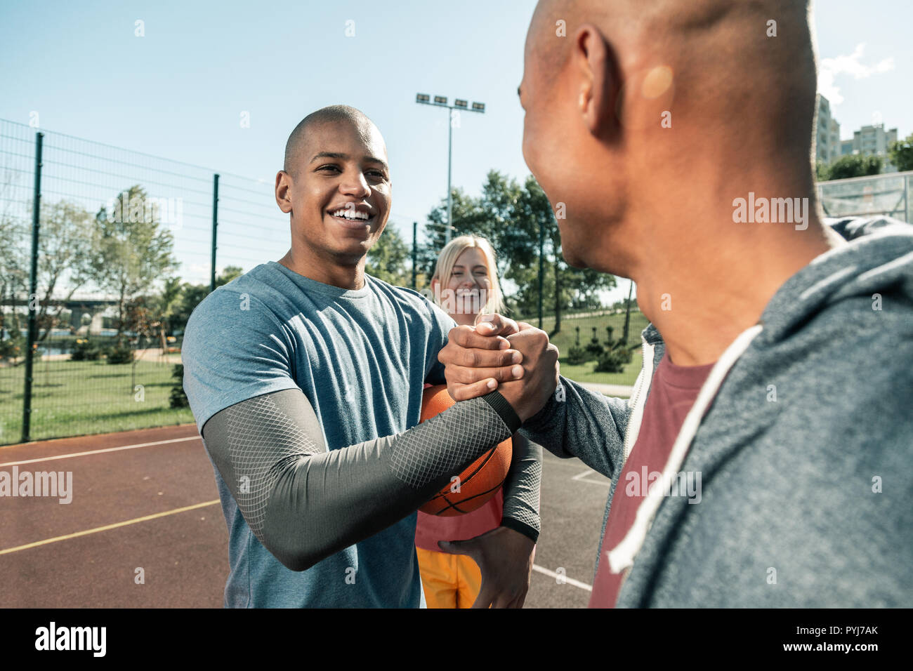 Positive young man looking at his coach Stock Photo - Alamy